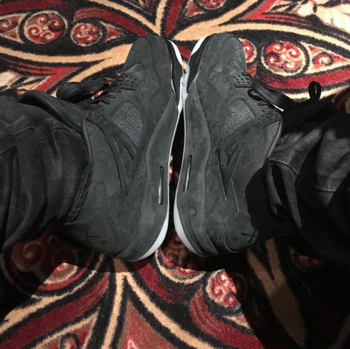 Drake Wears KAWS x Air Jordan 4 Black - Sneaker Bar Detroit